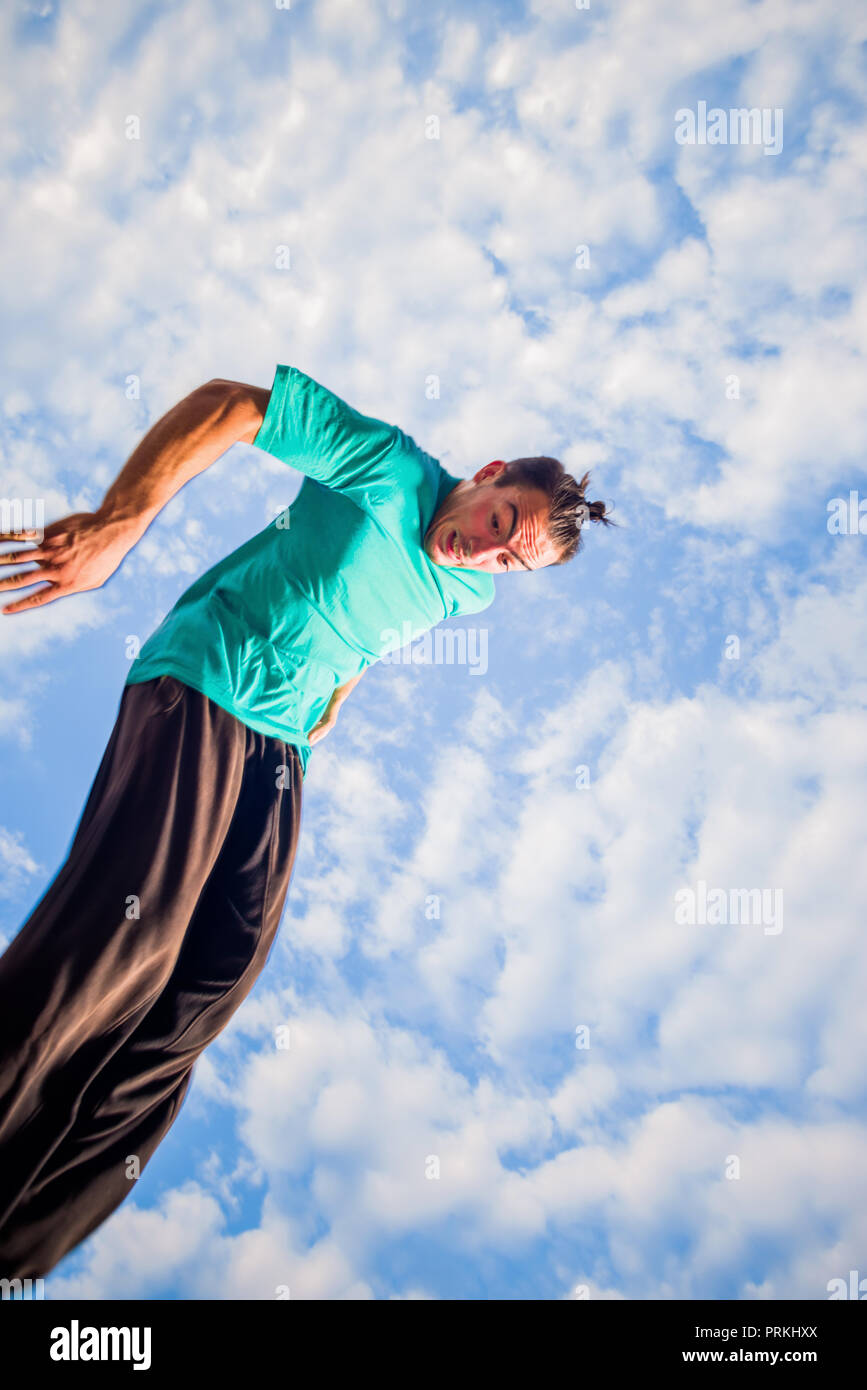 Free runner trains parkour while jumping in the air Stock Photo - Alamy