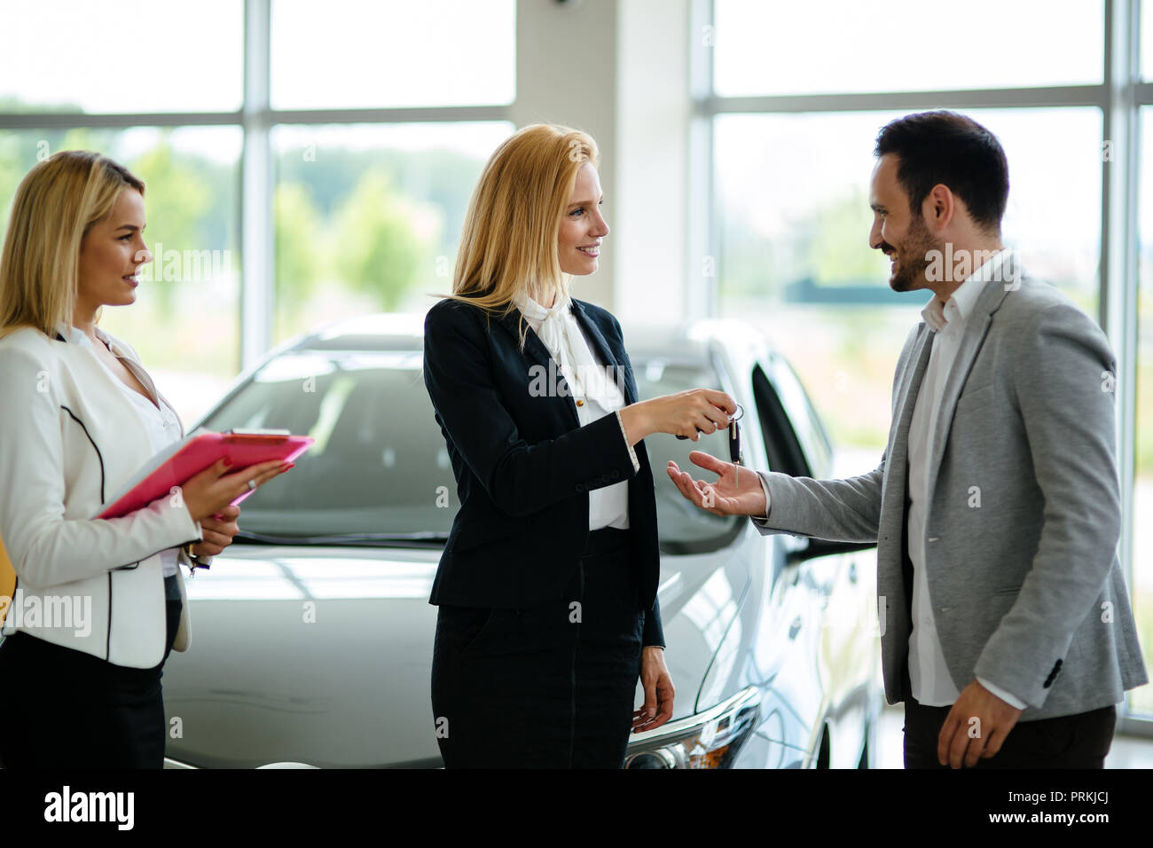 Portrait of happy customer buying new car Stock Photo - Alamy