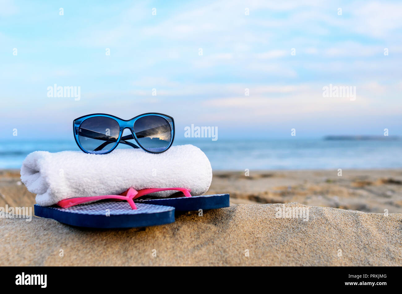 Flip-flops and sunglasses on the beach. At sunset Stock Photo - Alamy