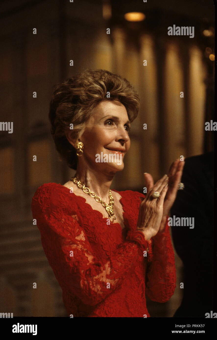 First Lady Nancy Reagan applauds President Reagan at a dinner to ...
