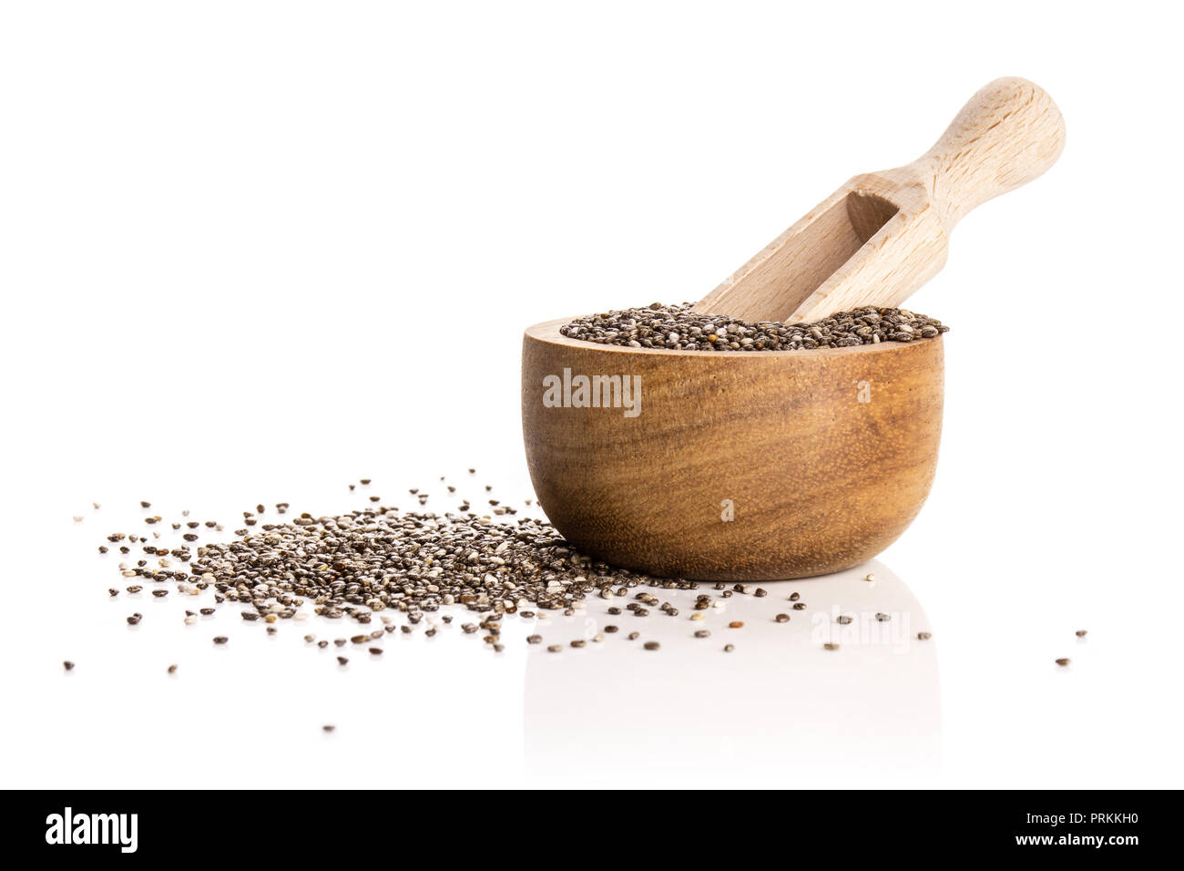 Composition of lot of whole fresh mottled chia seeds with wooden bowl ...
