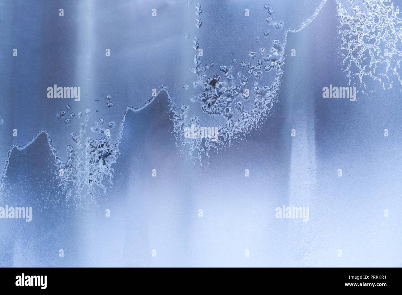 Wavy bizarre diagonal frosty pattern on blue frozen winter window Stock ...