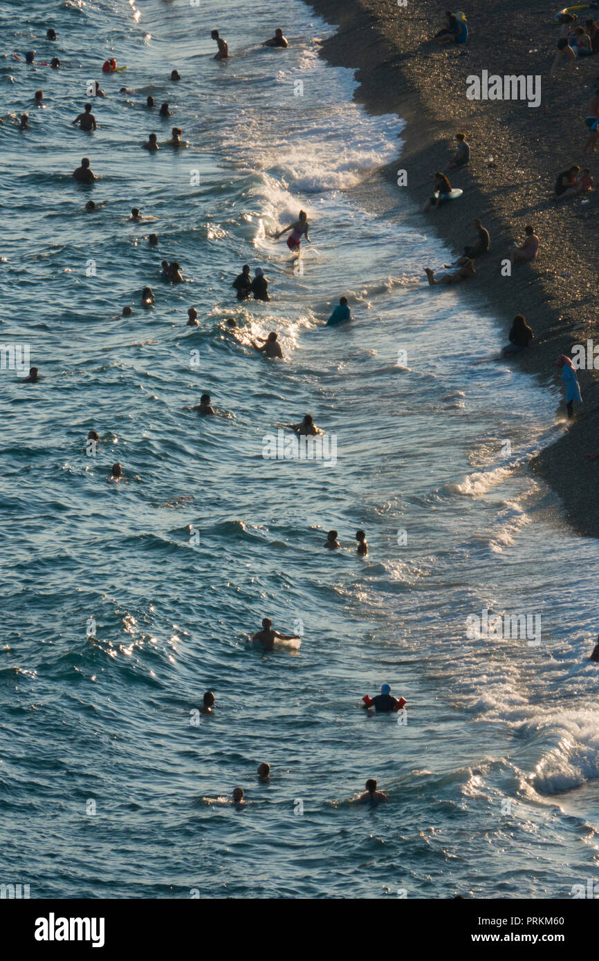 People swimming and sunbathing at beach in Antalya, Turkey Stock Photo ...