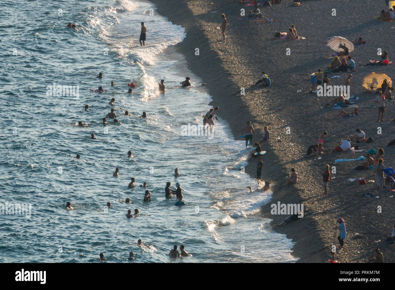 People swimming and sunbathing at beach in Antalya, Turkey Stock Photo ...