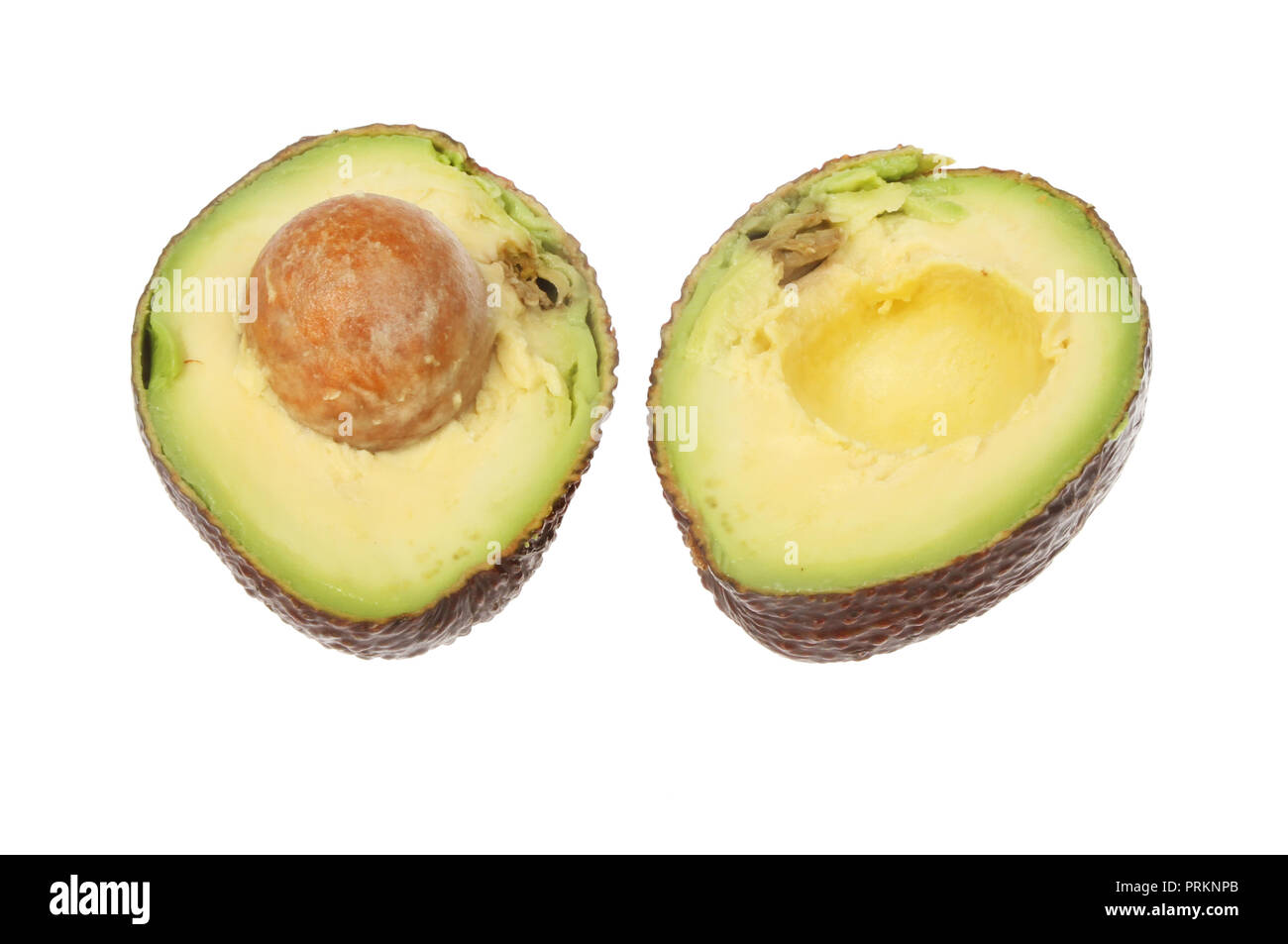 Avocado pear halves isolated against white Stock Photo - Alamy