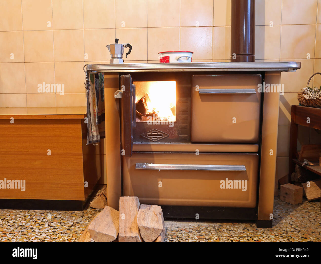 red fire lit in a stove with a mocha above Stock Photo - Alamy