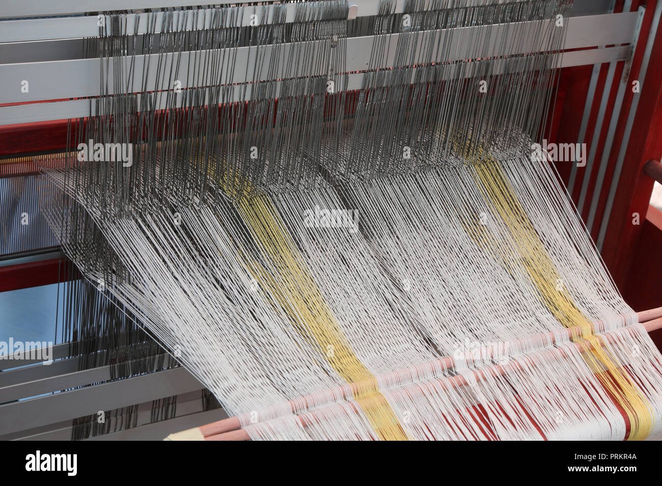antique frame for weaving yarns with colored threads Stock Photo - Alamy