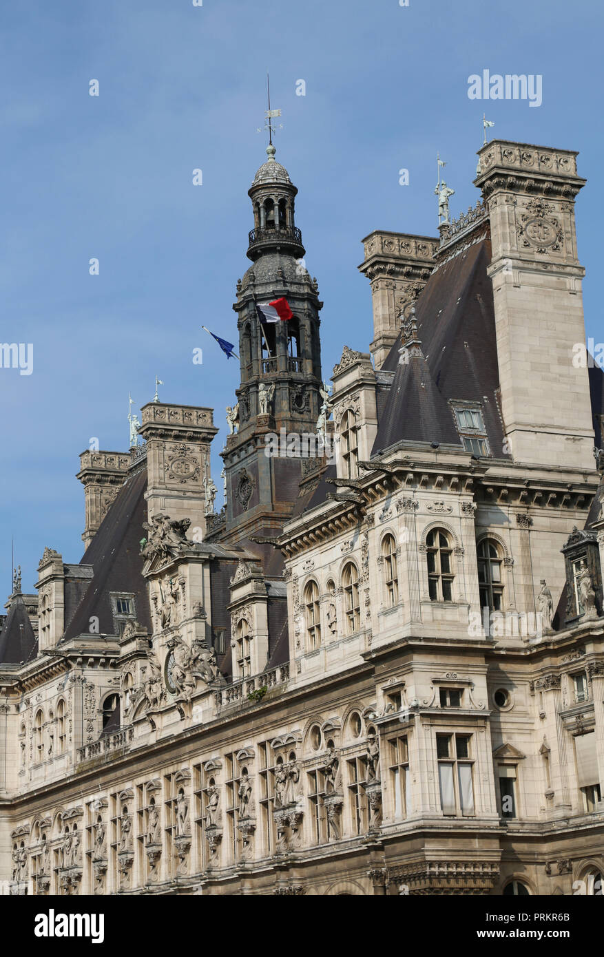 Town hall of Paris called Hotel de Ville in french language with flags ...
