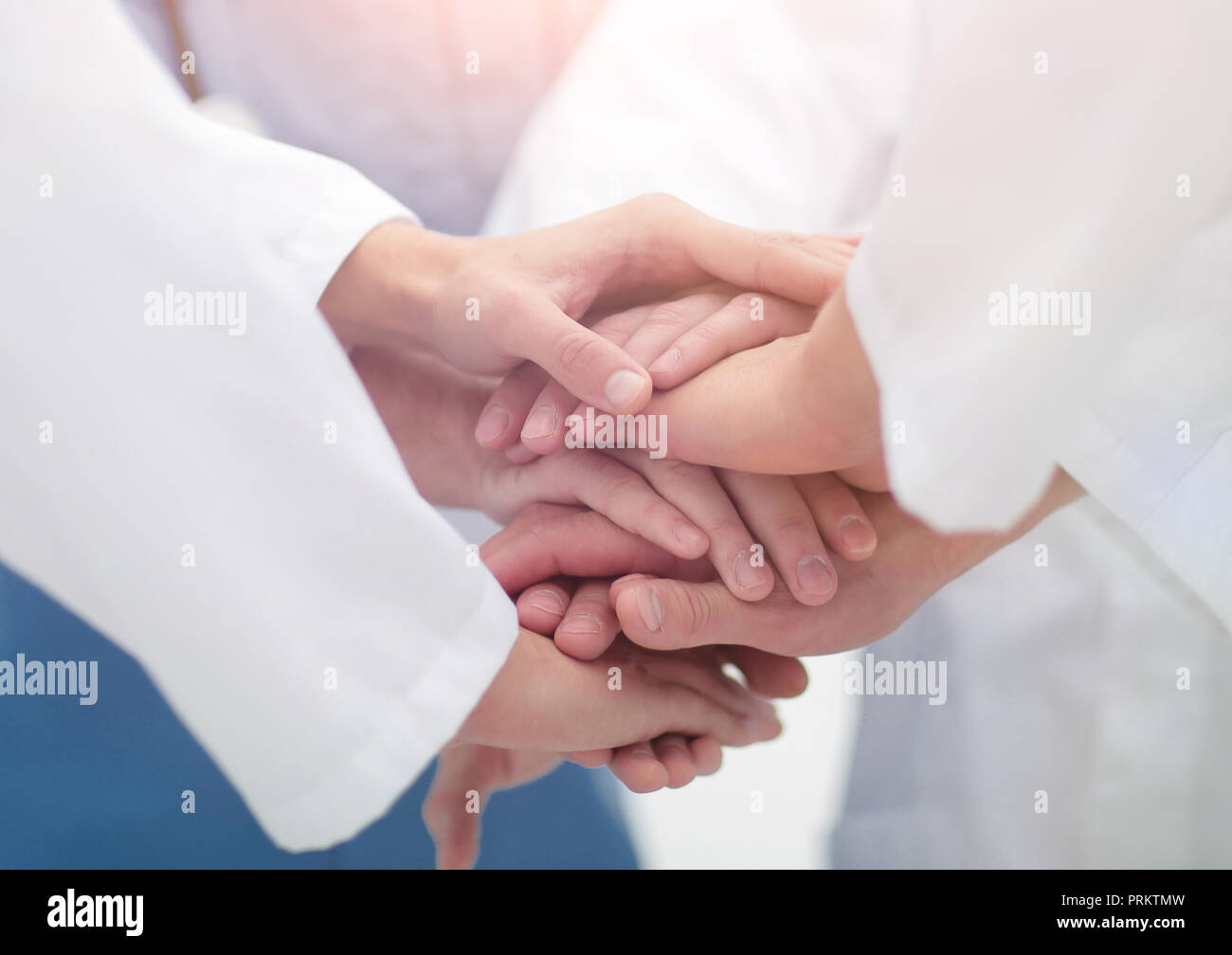 Group doctors joining hands hi-res stock photography and images - Alamy