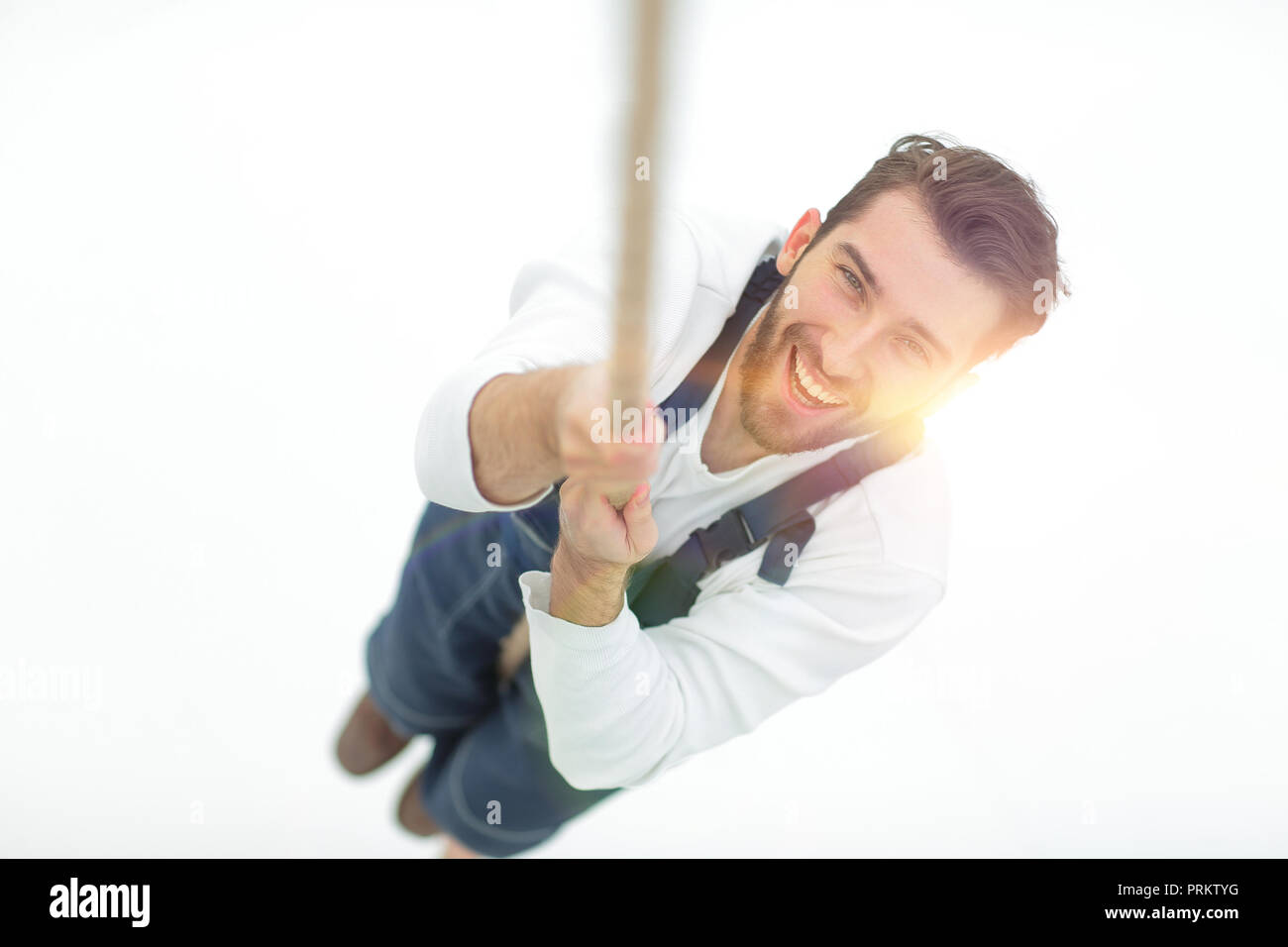 construction worker climbing the rope up Stock Photo - Alamy