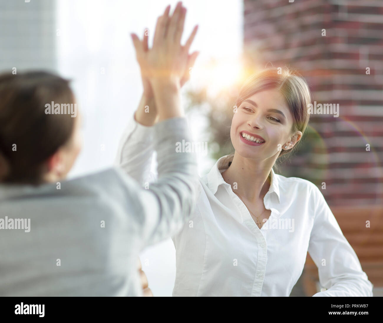 members of the business team giving each other a high five Stock Photo ...