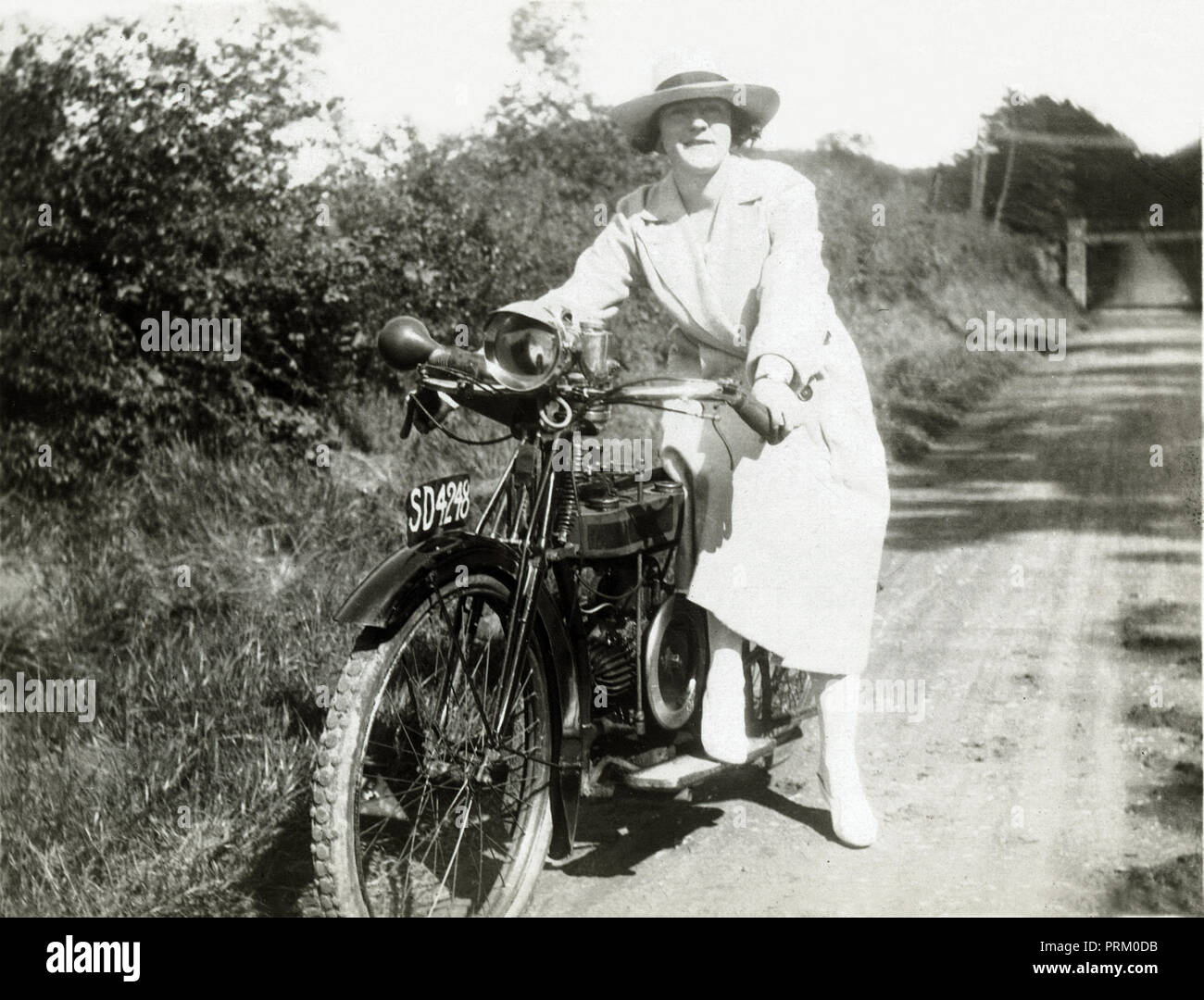 Lady poses for photograph on a 1920 Douglas 350cc Flat Twin motorcycle ...