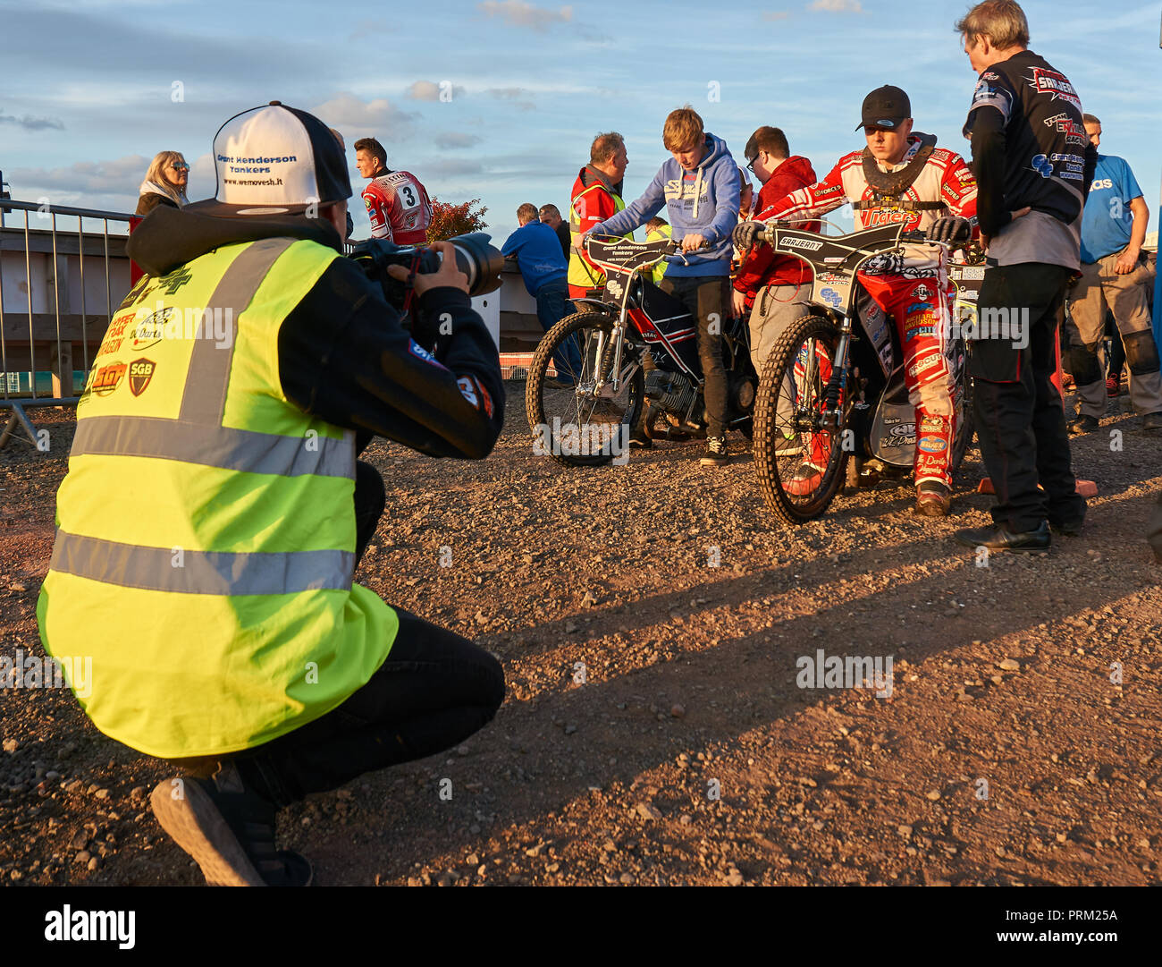Motorsport photographer at work photographing speedway riders of ...