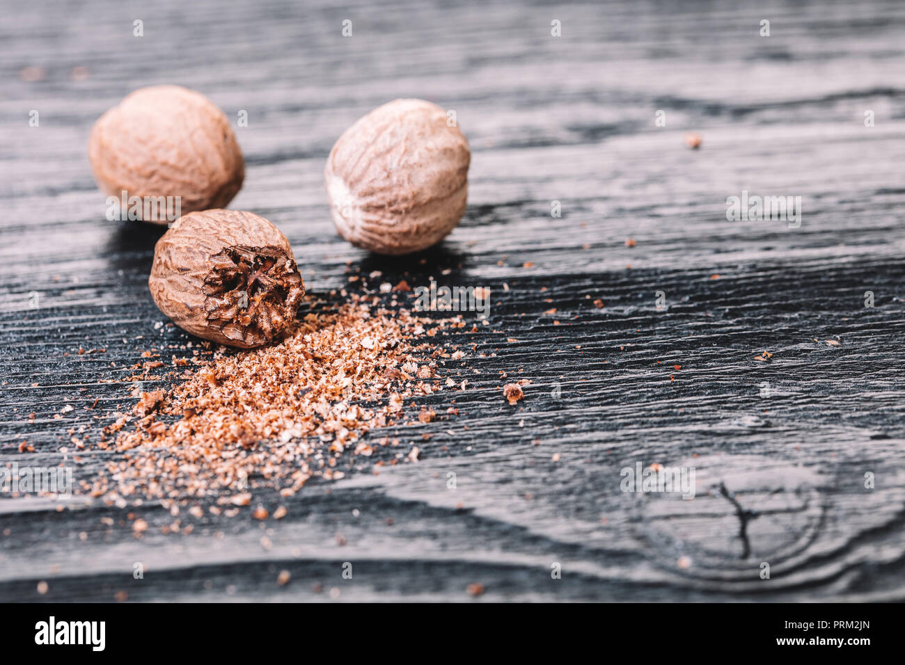 spices nutmeg closeup on a black wooden background Stock Photo - Alamy