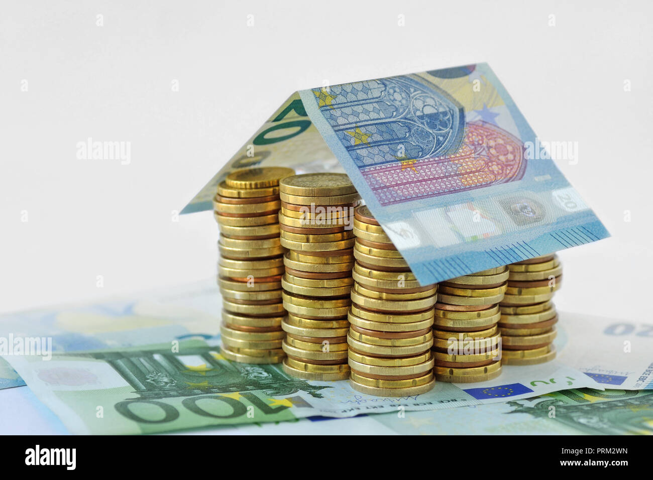 House built with euro coins and banknotes Stock Photo - Alamy