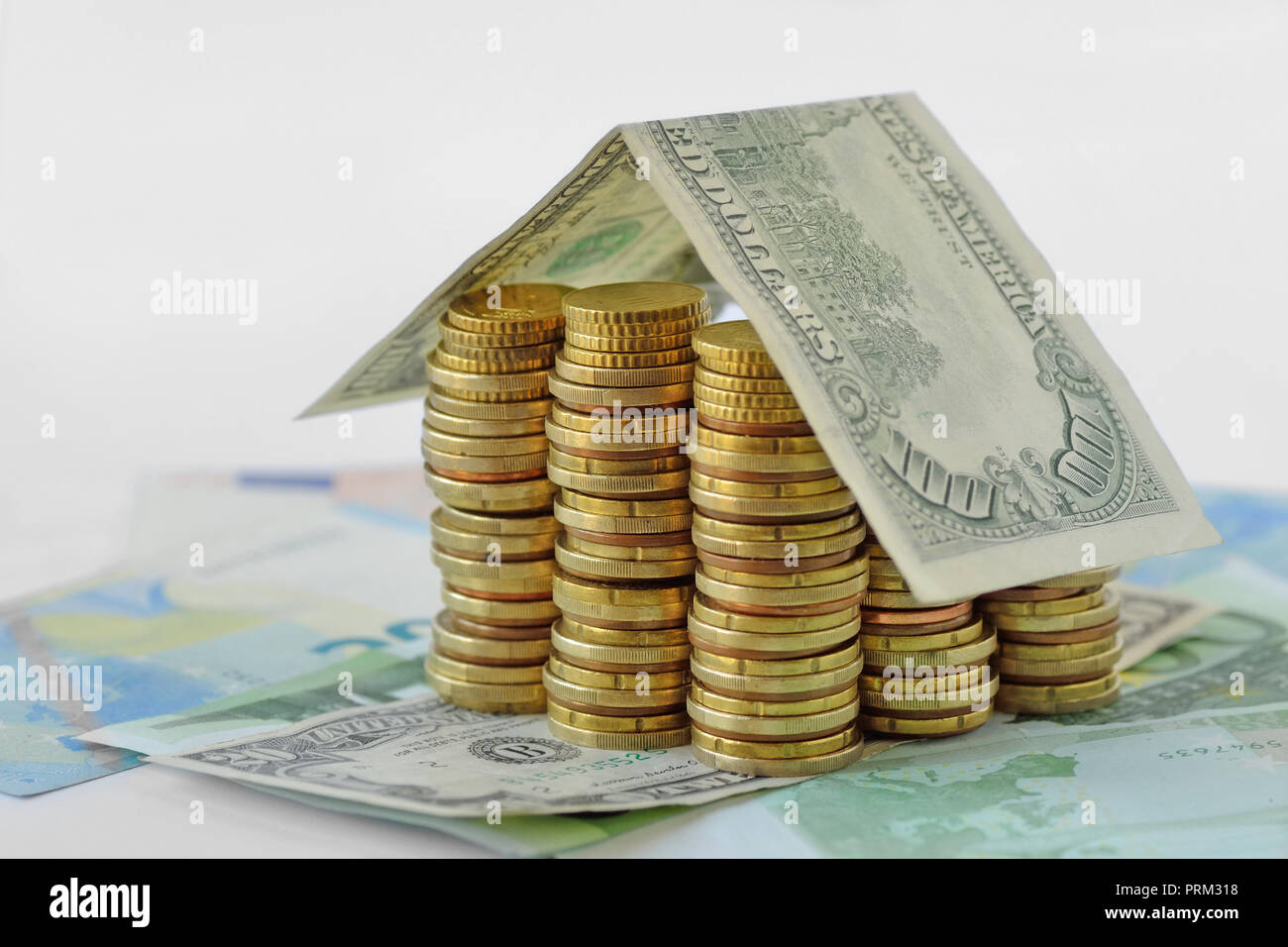 House built with coins and dollar banknote Stock Photo - Alamy