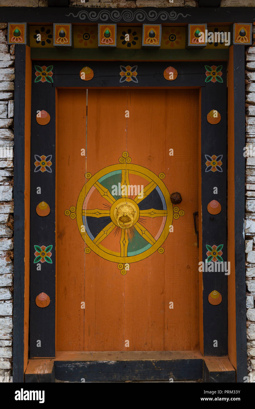 Closeup of traditional painting and carving on a door at the Paro Dzong ...