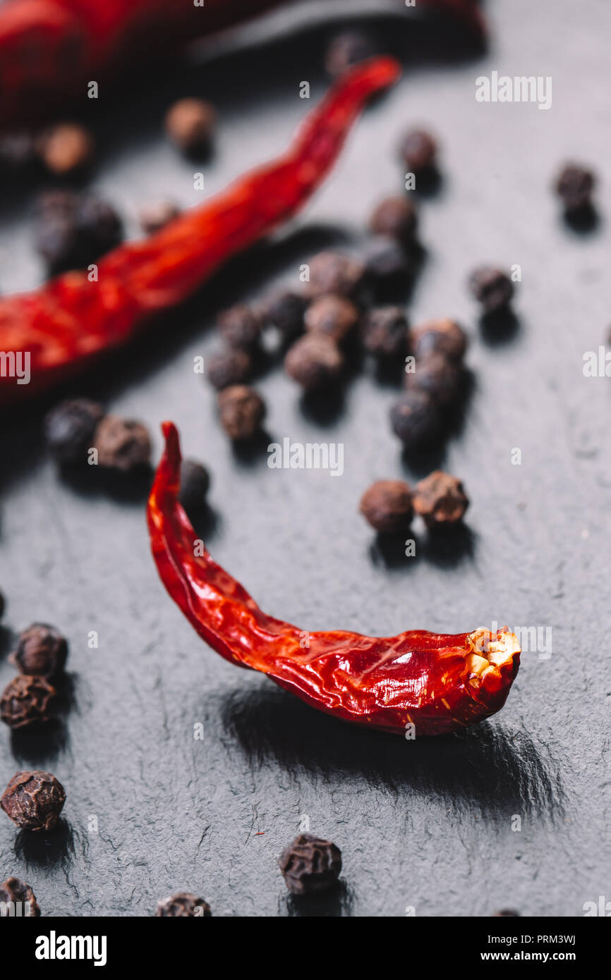food background dry spicy and fragrant peppers close-up on black Stock ...