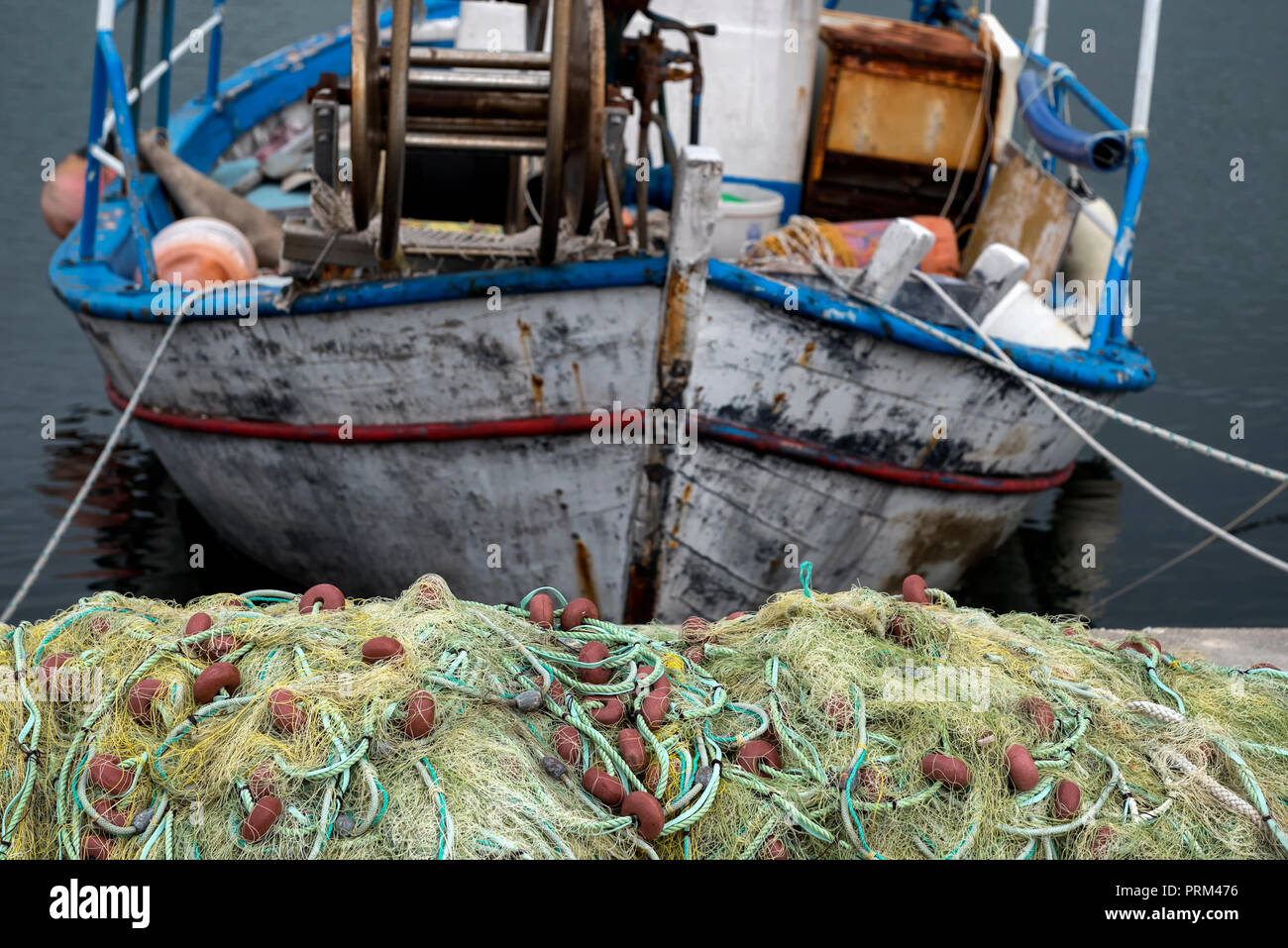 Fishing net with old boat in the background Stock Photo - Alamy