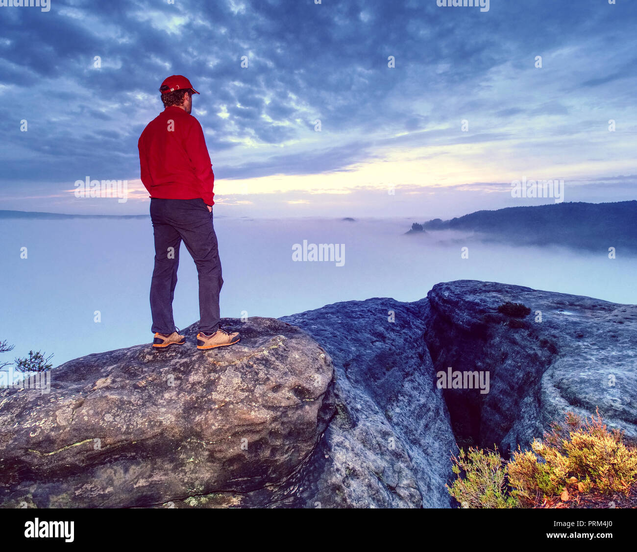 Tall guy with hands in pocket in blue shirt standing and watch the ...