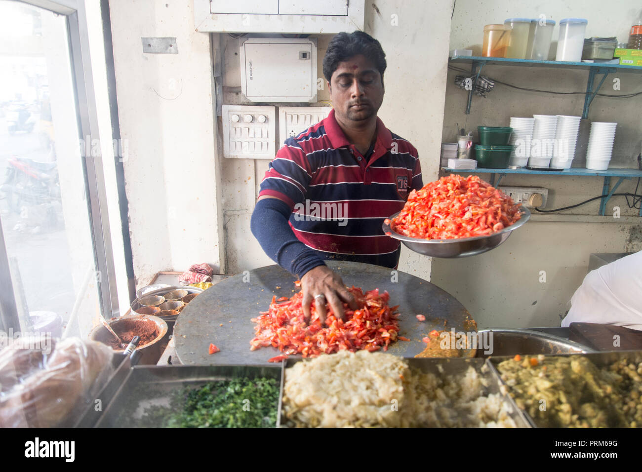 Preparing and selling Indian street food in a food stall. Photographed ...