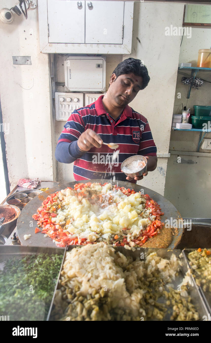 Preparing and selling Indian street food in a food stall. Photographed ...