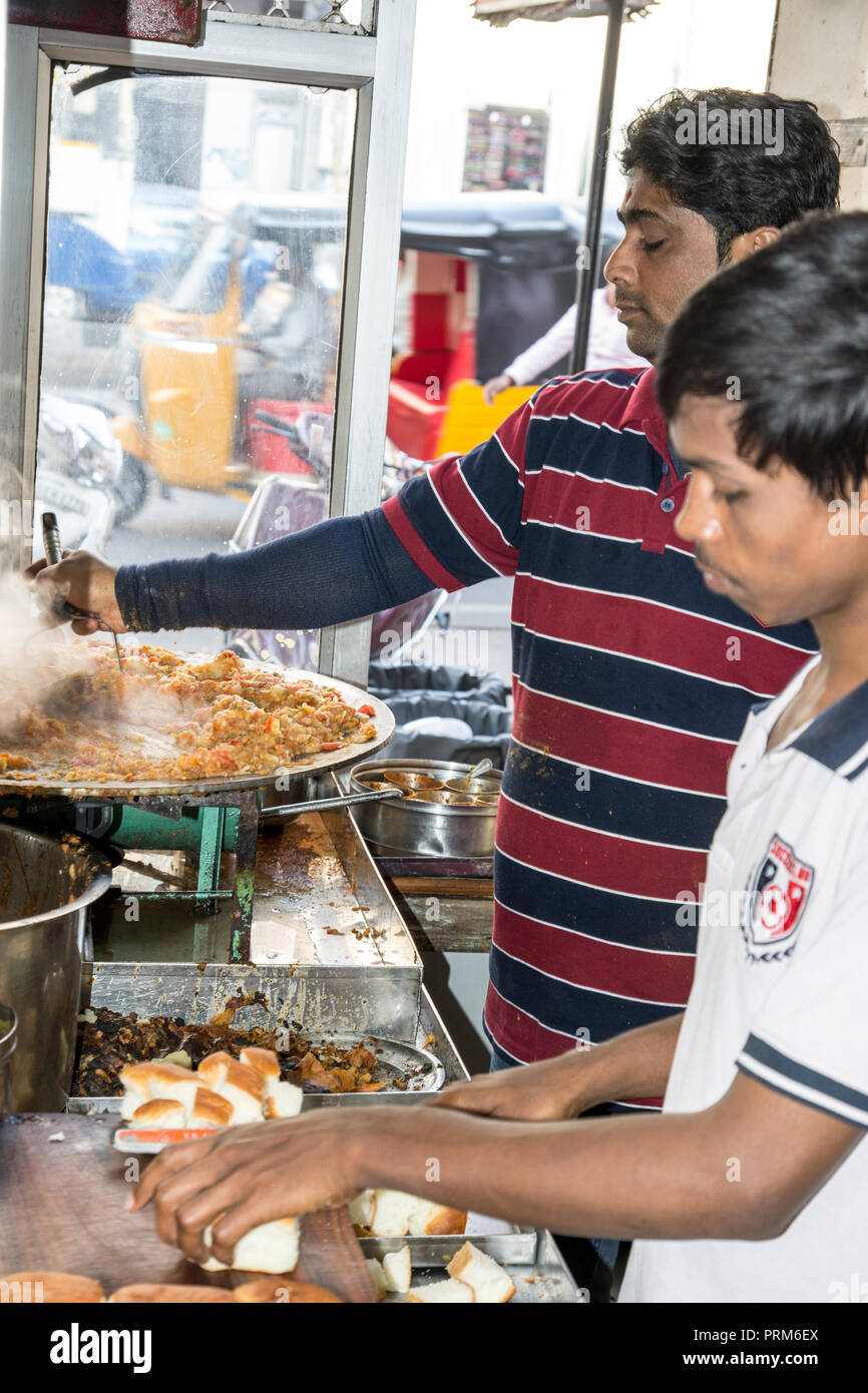 Preparing and selling Indian street food in a food stall. Photographed ...
