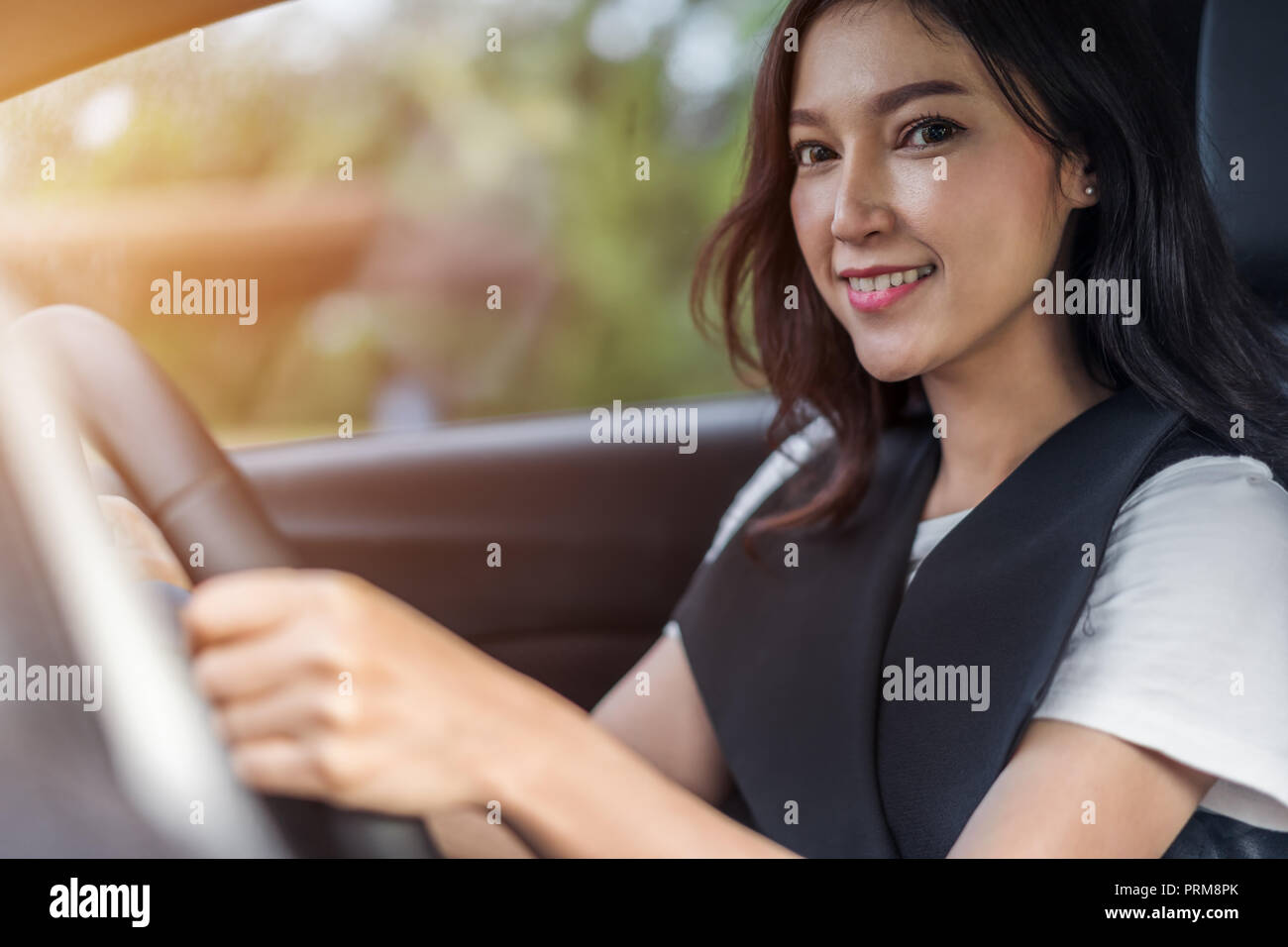 Young woman driving car in sunlight hi-res stock photography and images ...