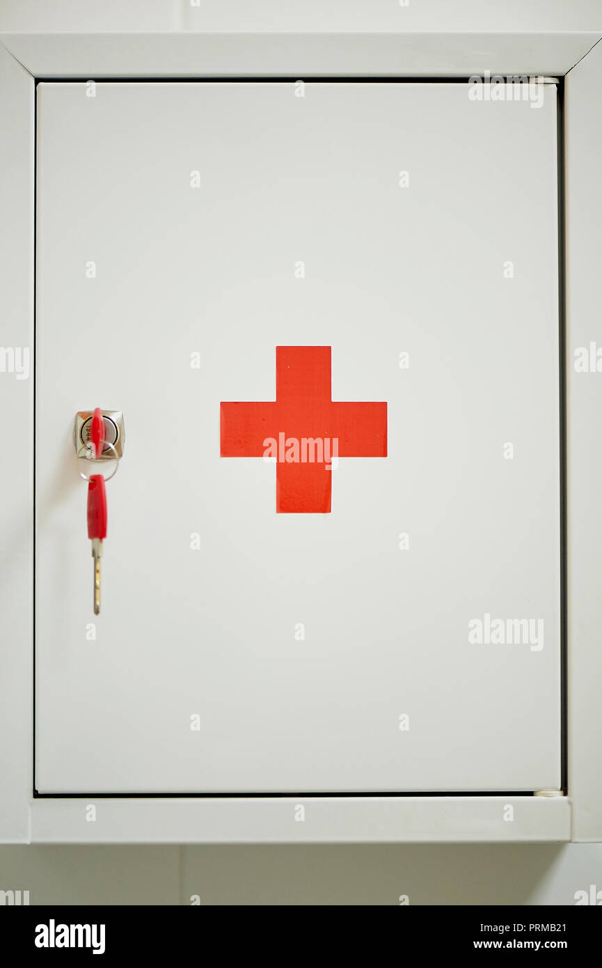 White hinged locker first aid kit, closed with a key.Medicine. First ...