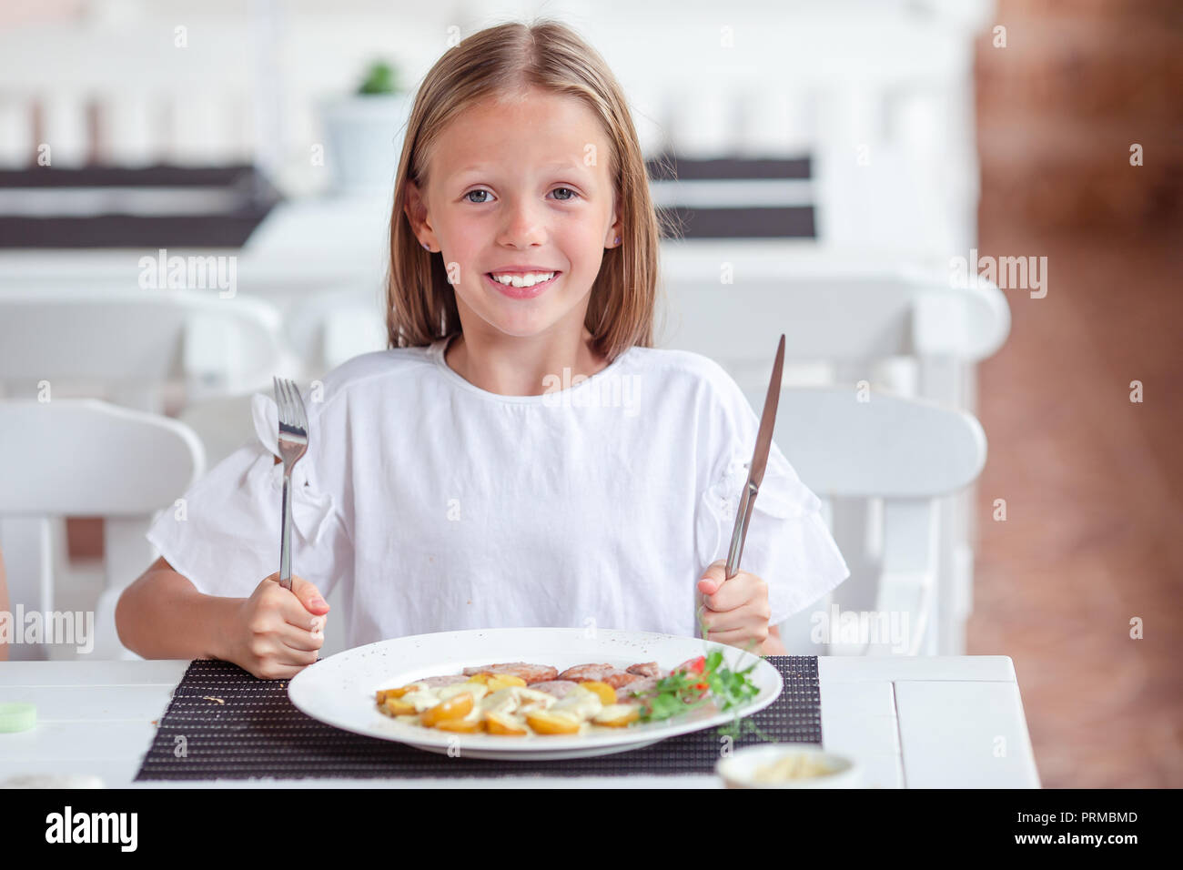 Adorable little girl having lunch at outdoor cafe Stock Photo - Alamy