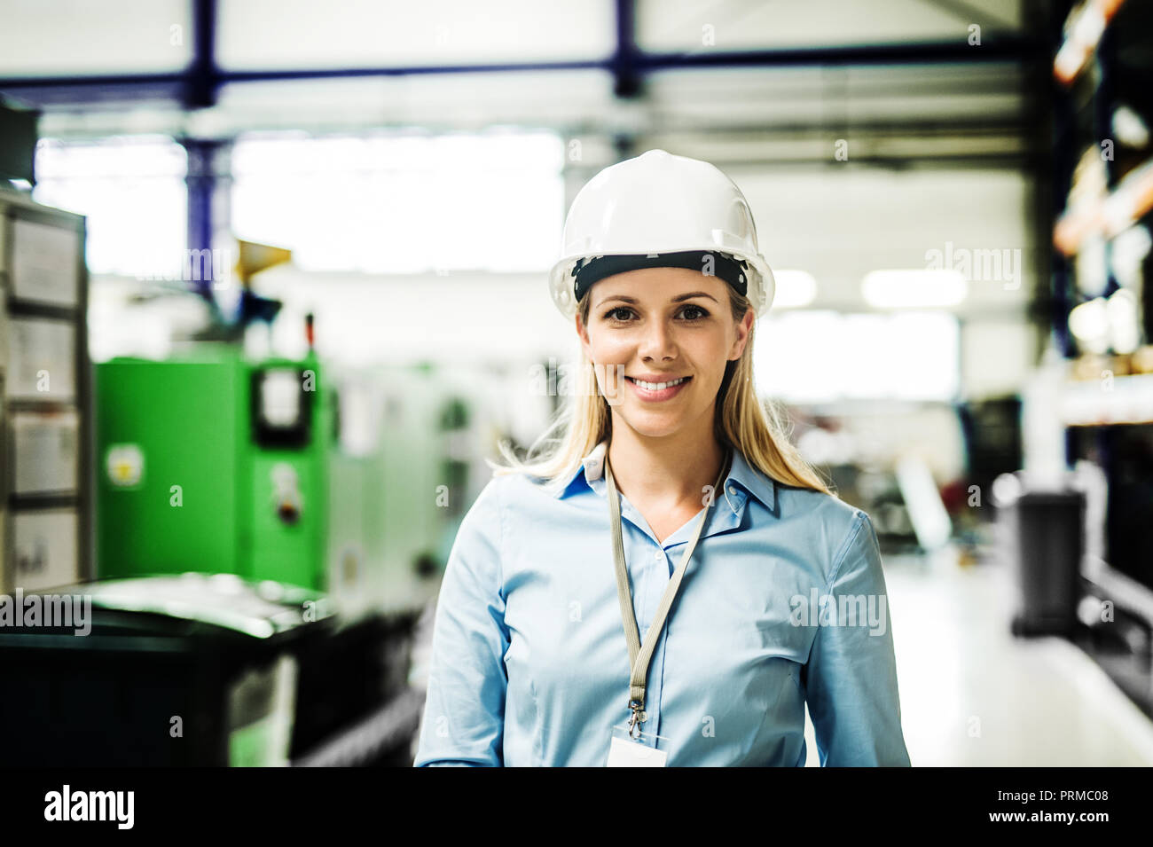 A portrait of an industrial woman engineer standing in a factory Stock ...