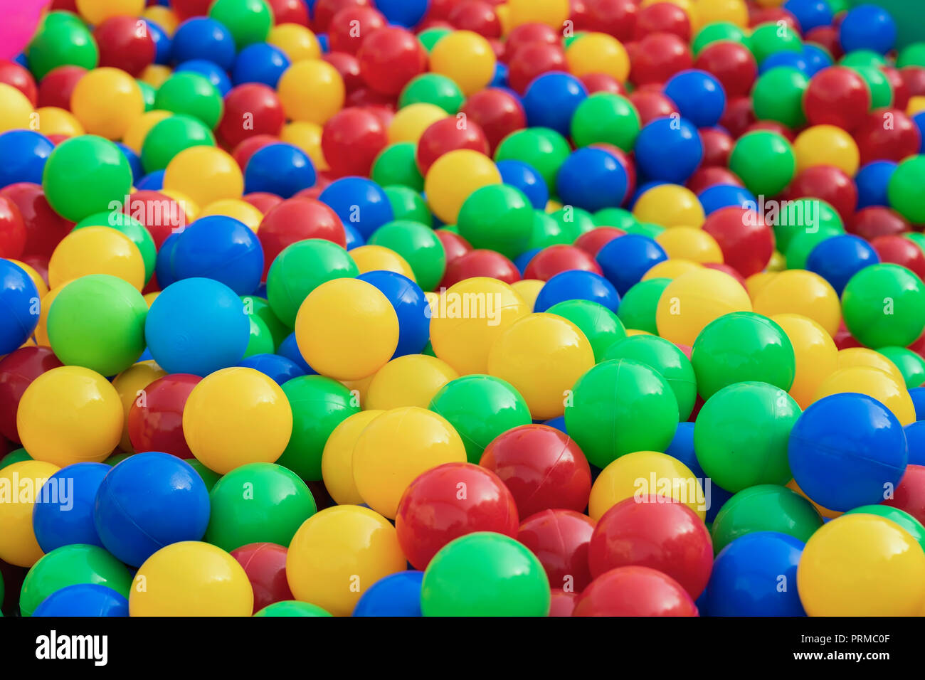 Colorful plastic multi-colored balls, bright background for children's ...