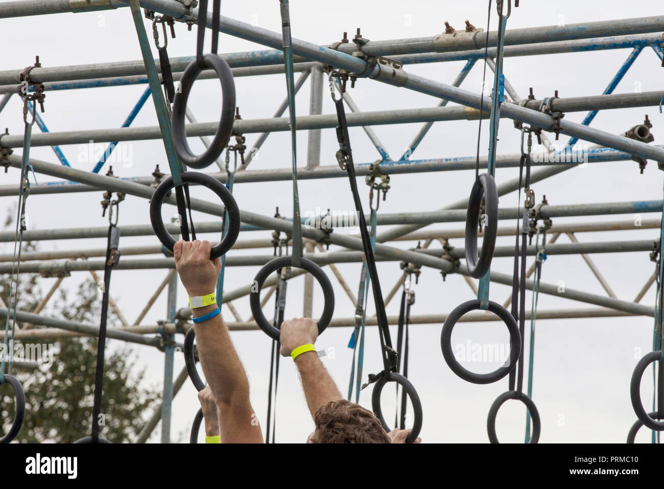 A person on hanging rings during an adventure obstacle course race ...