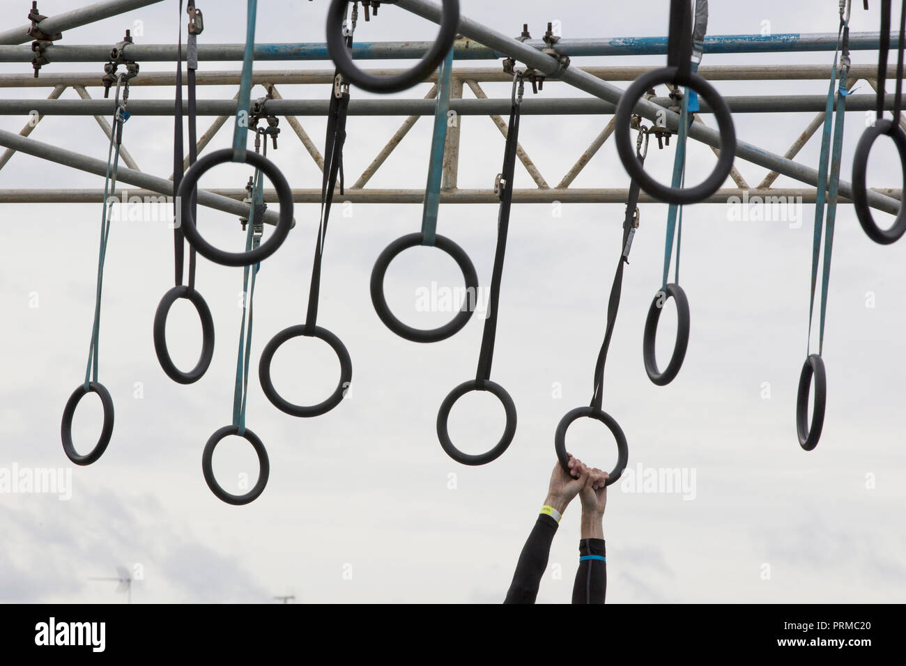 A person on hanging rings during an adventure obstacle course race ...