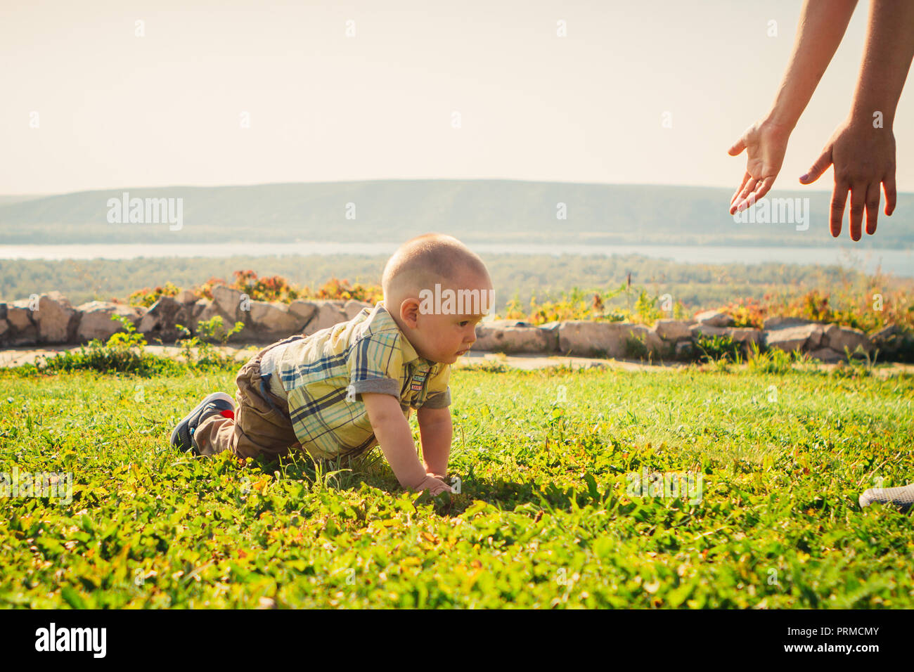 Baby boy on green grass nature background Stock Photo - Alamy