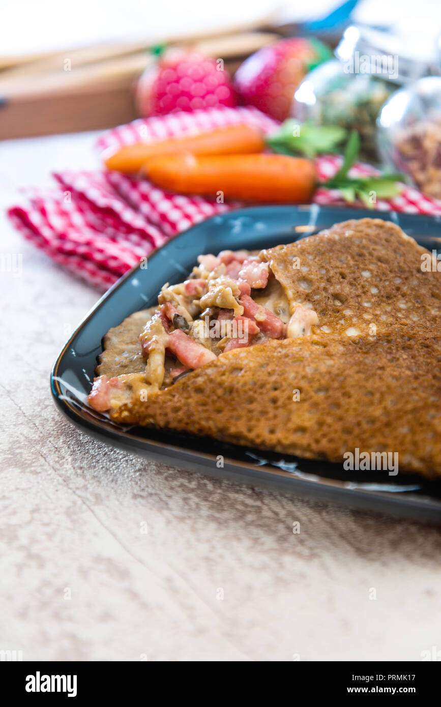 Black wheat and wheat galette topped with cooked ham and emmental ...