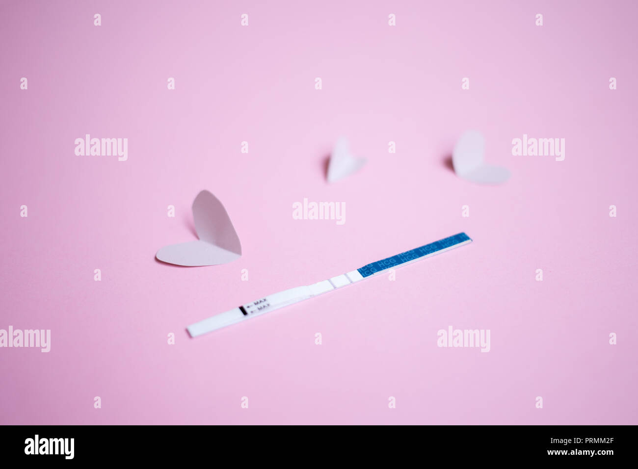 Positive pregnancy test with two strips and pink hearts. pink ...