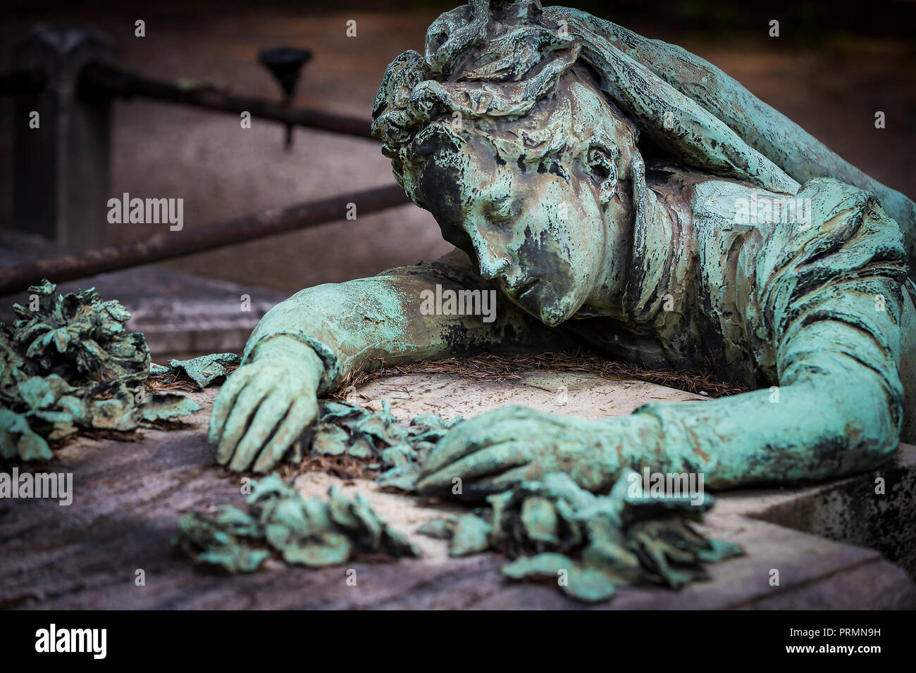 MILAN, ITALY - JUNE 6, 2018 : Statues of mourning at the graves of the ...
