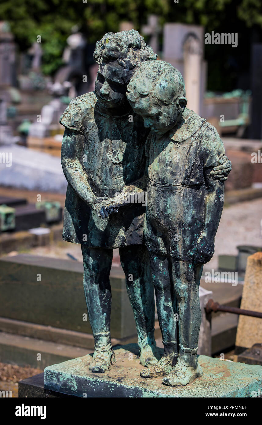 MILAN, ITALY - JUNE 6, 2018 : Statues of mourning at the graves of the ...