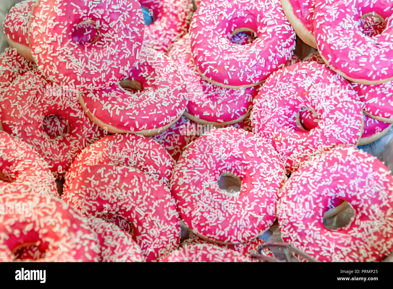 Background of pink donuts with sprinkles Stock Photo - Alamy