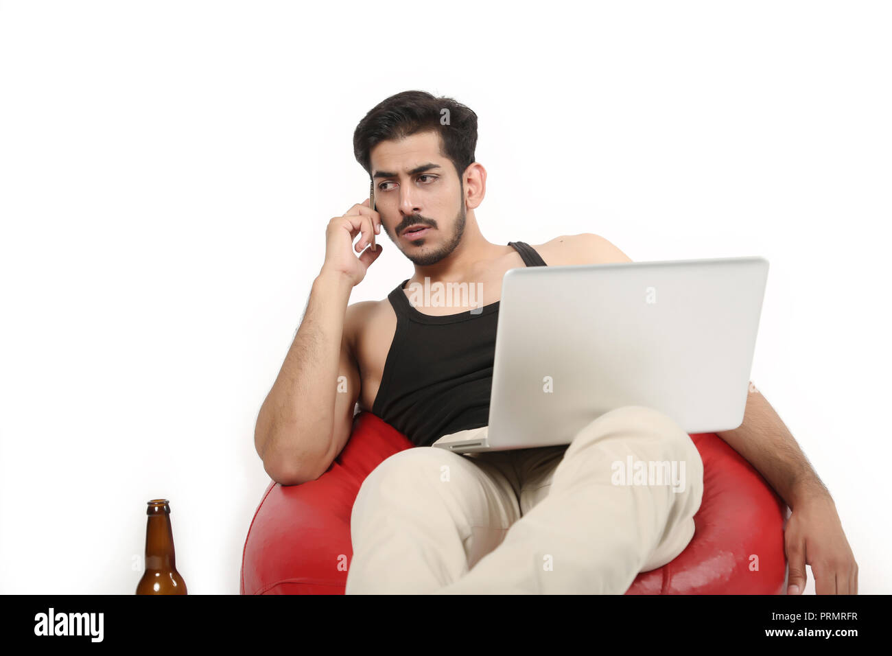 Picture of smart boy sitting on the bean bag couch. Boy talking on ...