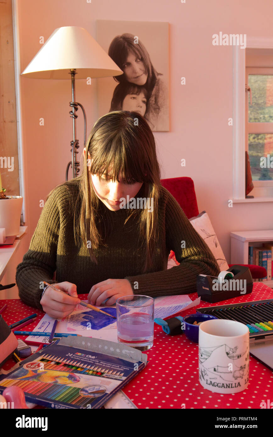 Girl being creative with watercolour pencils Stock Photo - Alamy