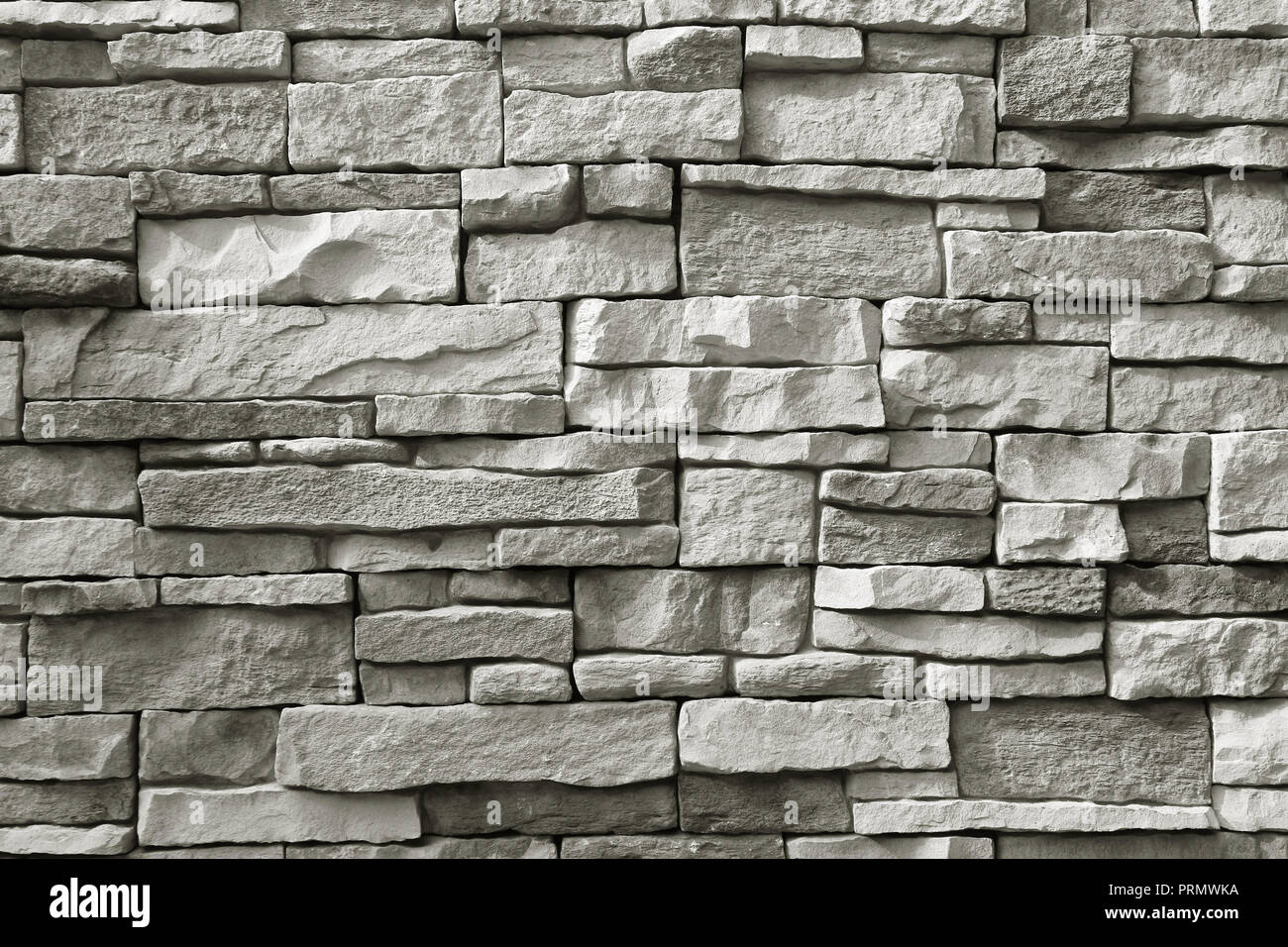 Front view of monotone grey rough stone wall for background or banner ...