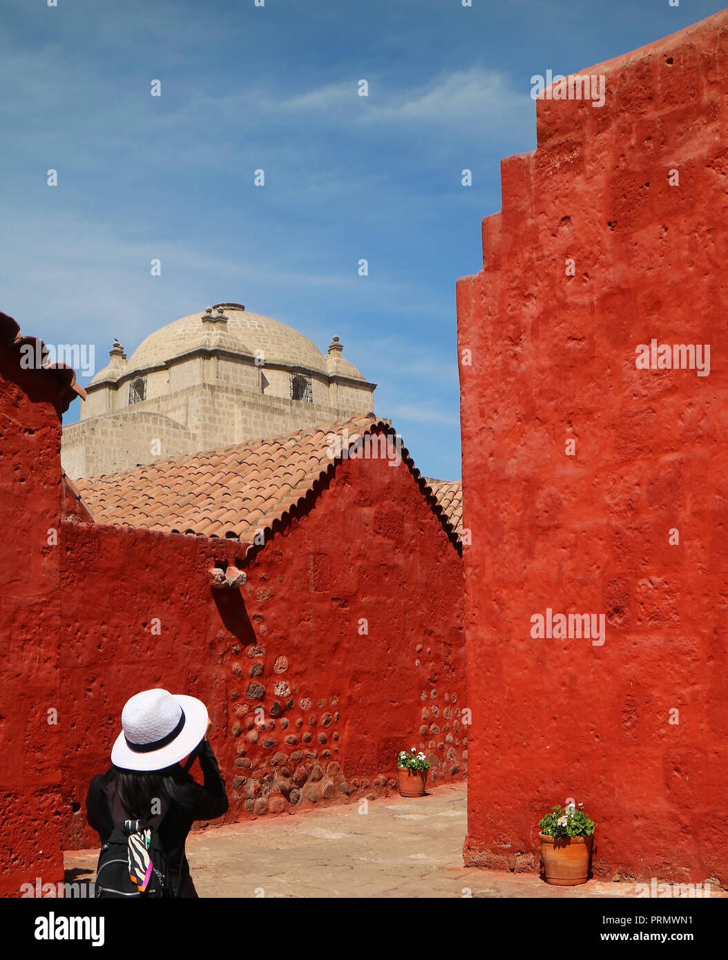 Woman taking pictures of vivid color buildings in Santa Catalina ...