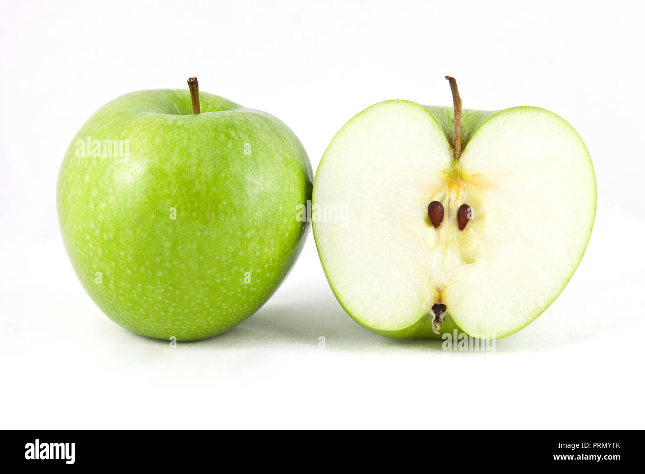 Green apple portion on white background Stock Photo - Alamy