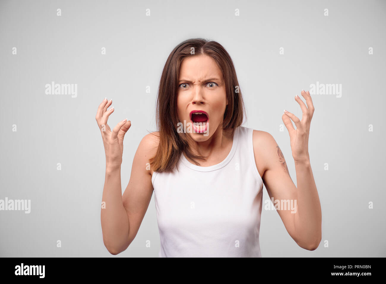 Angry woman looking at camera. Aggressive business woman standing ...