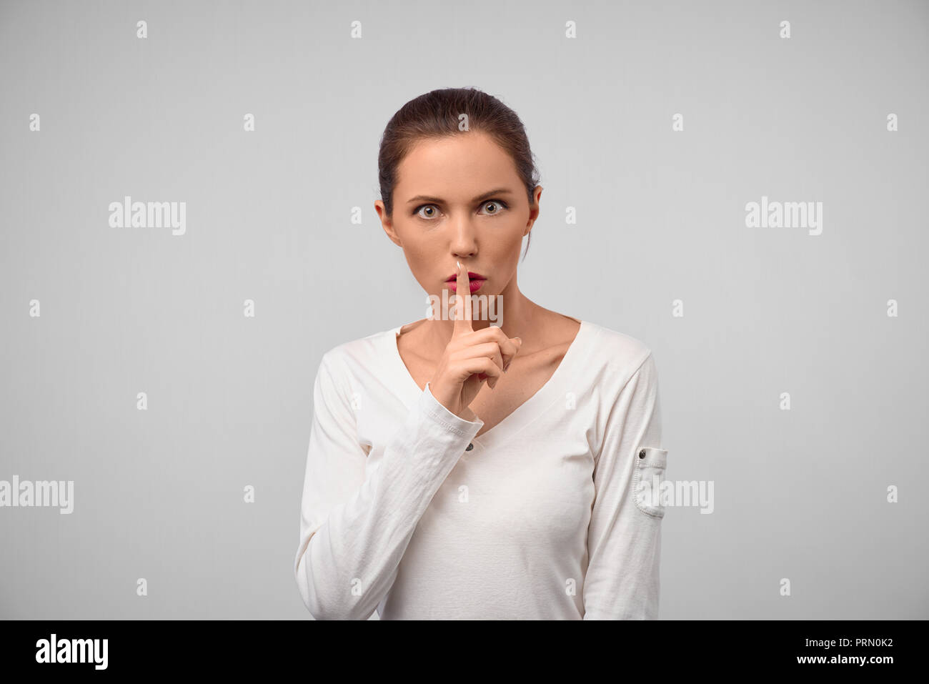 Finger over mouth shh hi-res stock photography and images - Alamy