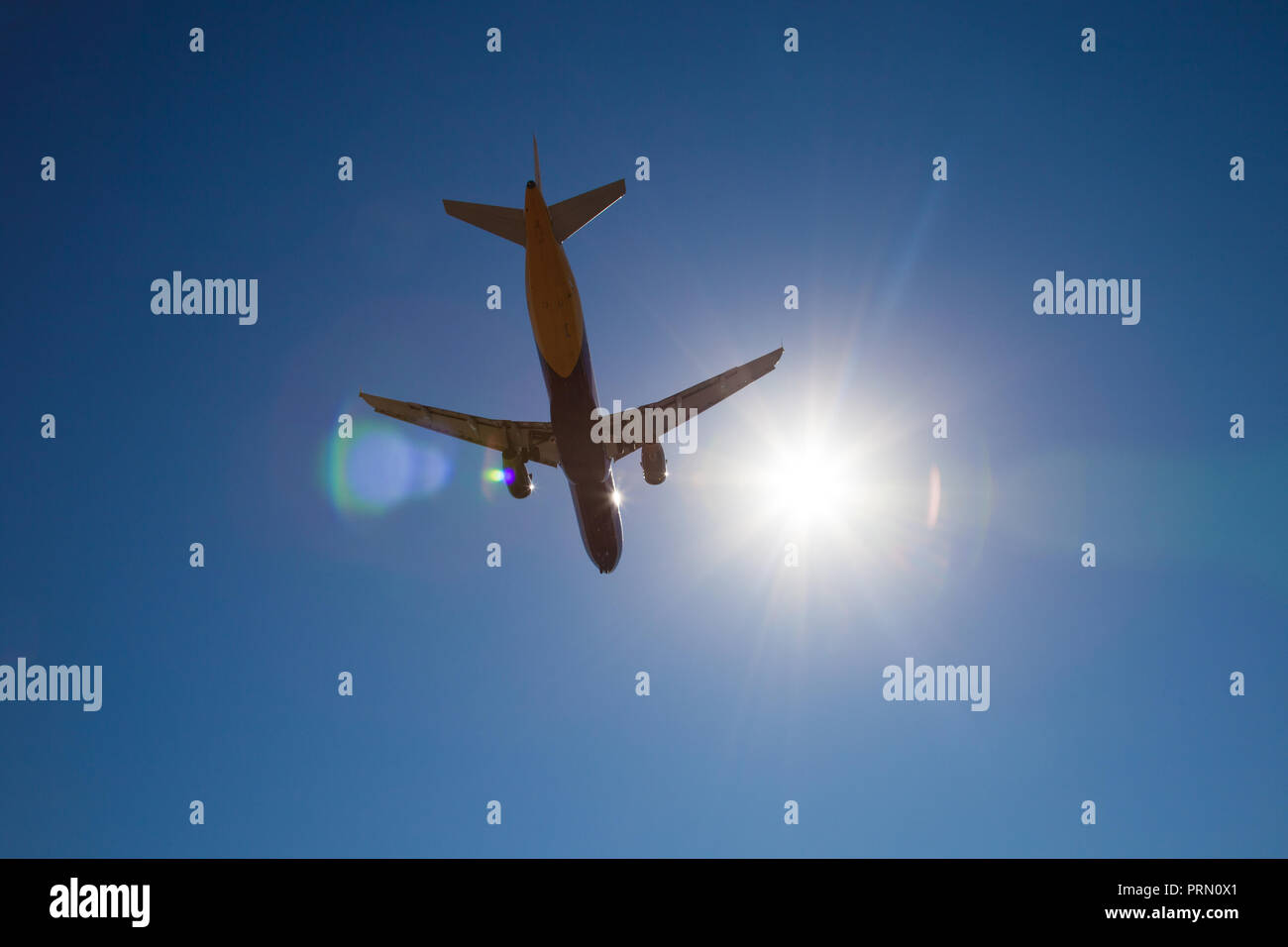 aircraft flying in a blue sky Stock Photo - Alamy