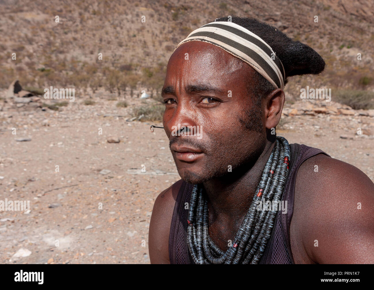 Himba tribe man with the traditional necklace, Cunene Province, Oncocua ...