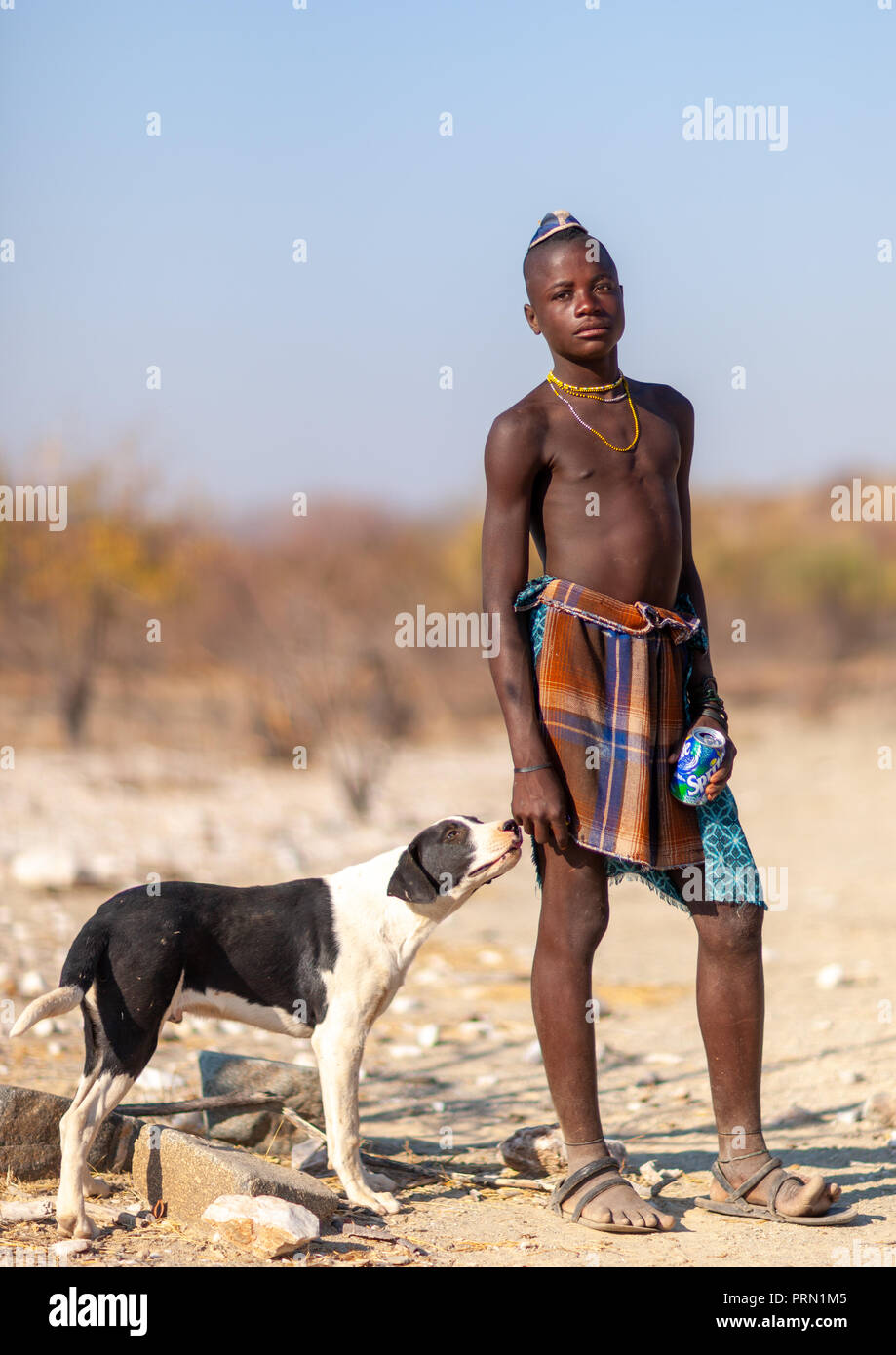 Himba tribe young man with a dog, Cunene Province, Oncocua, Angola ...